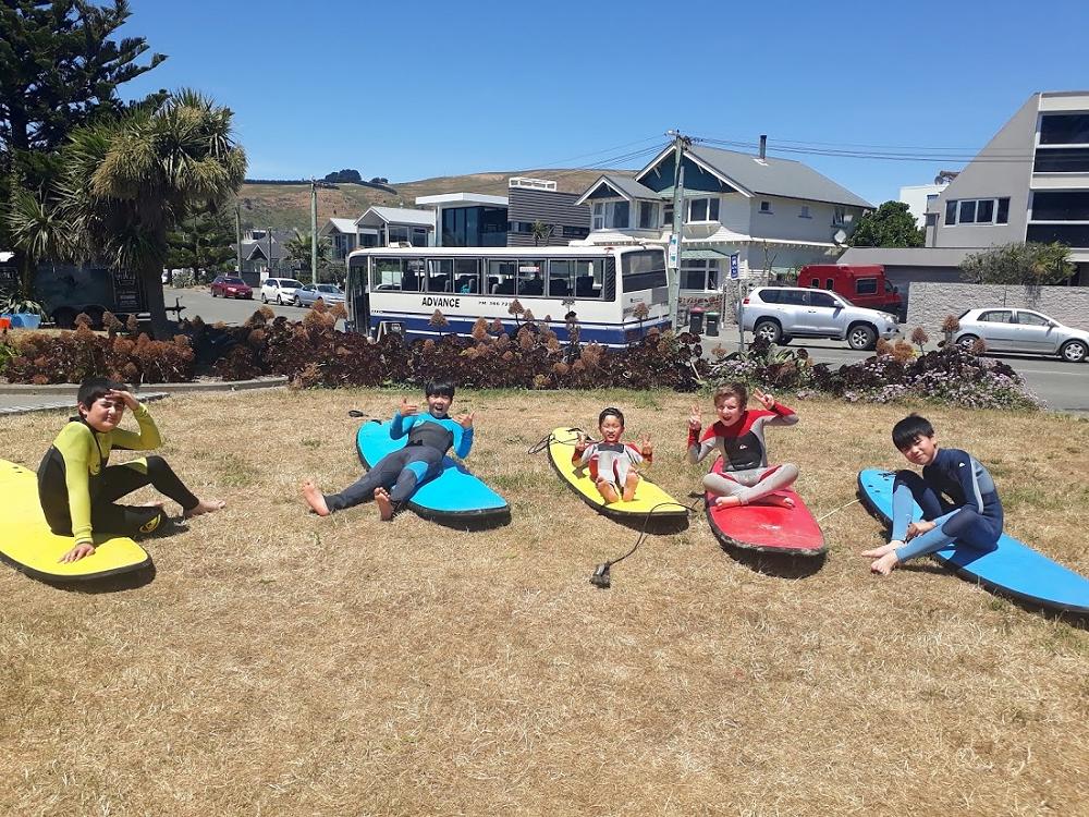 Tuakana Whetu goes surfing at Sumner Beach